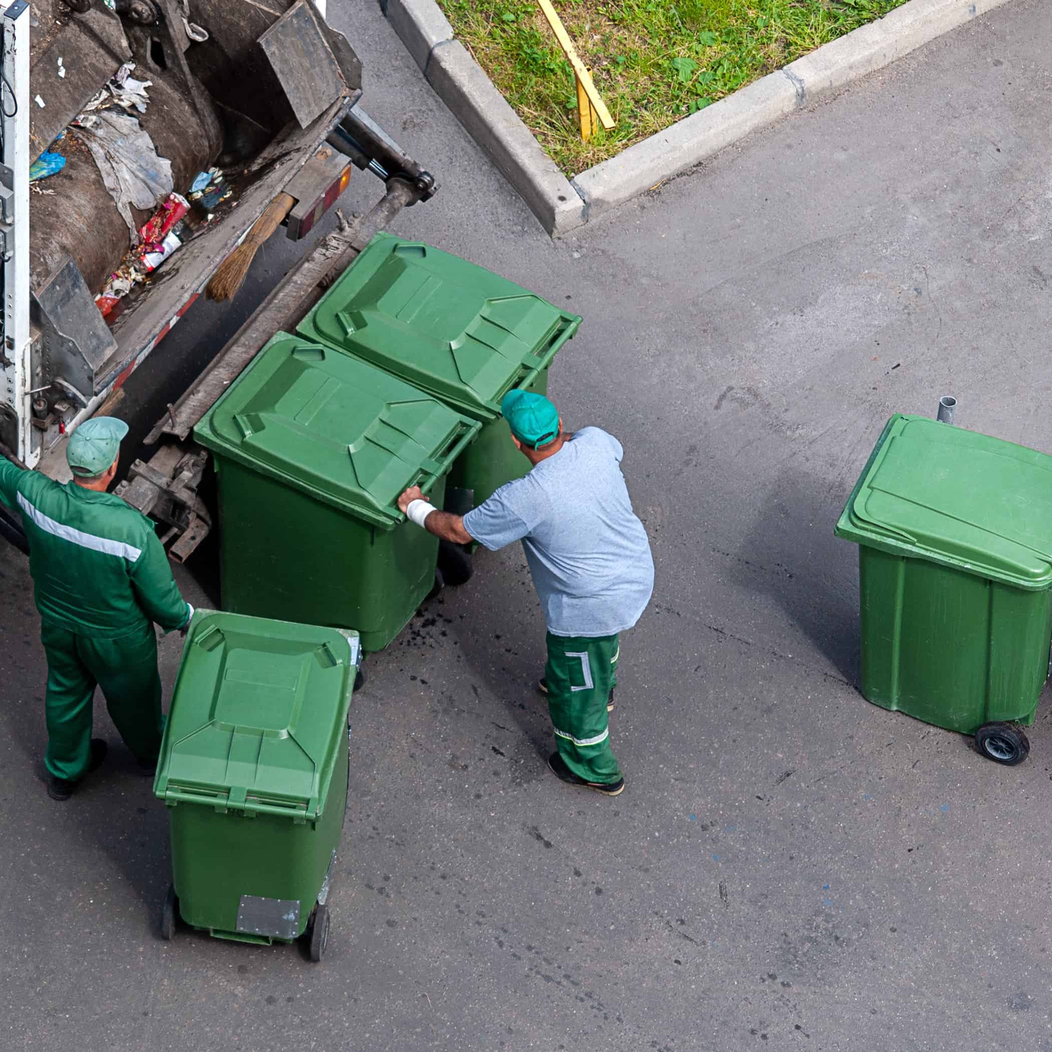 garbage men loading household rubbish in garbage truck, view from above ...